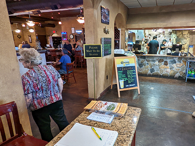 Where magic happens: That "Please Wait To Be Seated" sign might as well say "Prepare For Deliciousness" as kitchen aromas waft through the dining room.