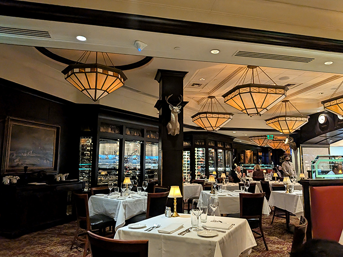 Warm amber lighting cascades from geometric chandeliers while polished wood creates an atmosphere where even James Bond wouldn't mind waiting for his martini. 