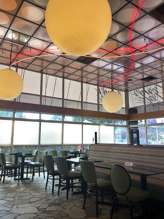 Those playful yellow orbs floating overhead aren't UFOs—they're the signature light fixtures that make Corner Cafe feel like dining inside a cheerful modern art installation.