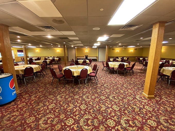 The dining room says "make yourself at home." Yellow walls, patterned carpet and tables draped in white cloths create the perfect backdrop for family gatherings and food-focused conversations.