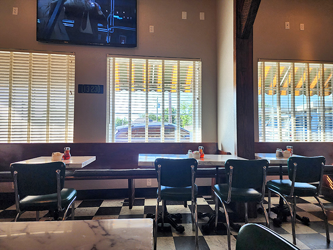 Inside, the black and white checkered floor sets a timeless stage for culinary magic. Whoever designed this place understood the psychology of comfort.