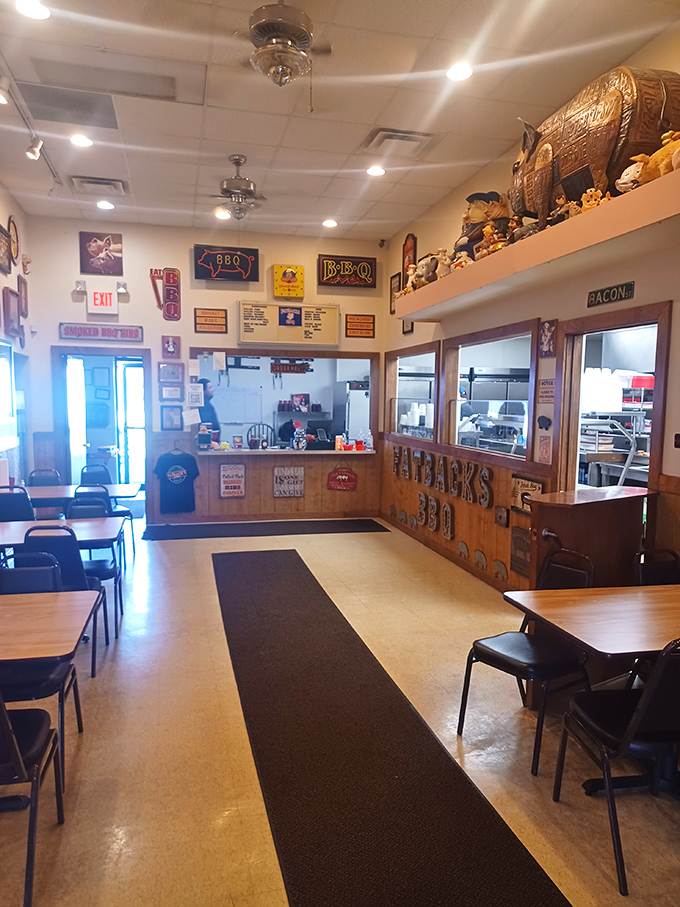 Simple tables, no-nonsense decor, and that black runner carpet saying, "Follow me to the good stuff." BBQ joints know priorities.