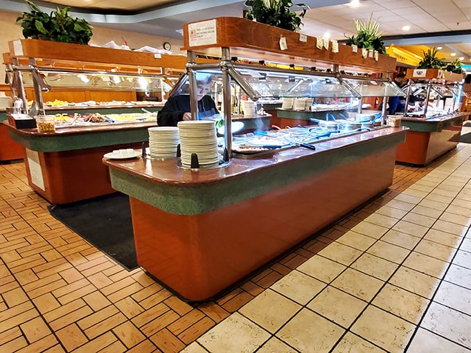 Buffet stations stretch to the horizon like a food mirage, gleaming under warm lights. The journey of a thousand bites begins with a single plate.