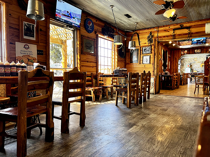 Rustic wooden walls and hand-crafted furniture create the perfect backdrop for serious eating—like dining in a deluxe treehouse built for barbecue enthusiasts.