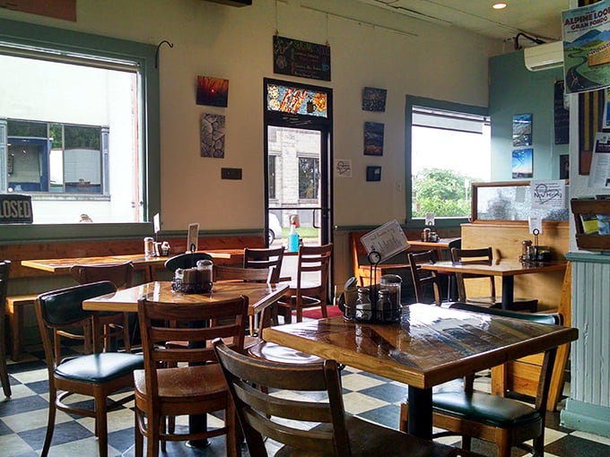 Wooden tables, checkerboard floors, and sunlight streaming through windows create that rare atmosphere where time slows down and conversations flourish.