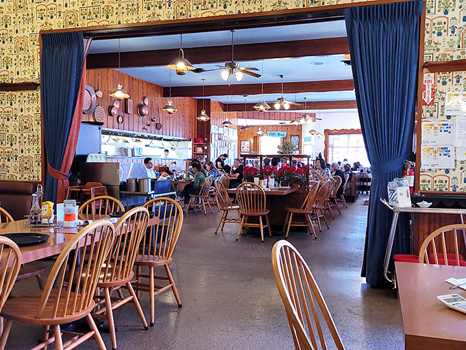 Where wooden Windsor chairs and blue curtains create the perfect time capsule. Comfort doesn't need to be trendy to be perfect.