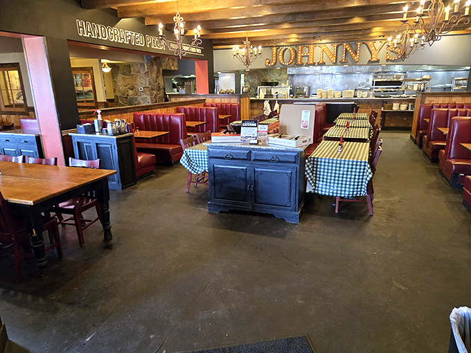 Inside, the classic Italian trattoria vibe comes alive with burgundy booths, checkered tablecloths, and warm lighting that makes everyone look like they're in a Fellini film.