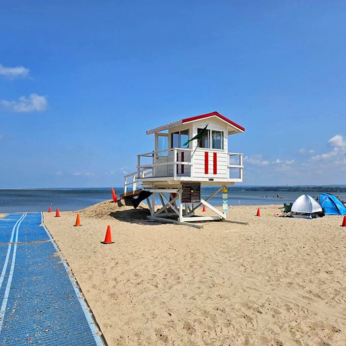 The classic red and white lifeguard tower stands sentinel over Beach 11, a reassuring presence that says, "Go ahead, the water's fine!"