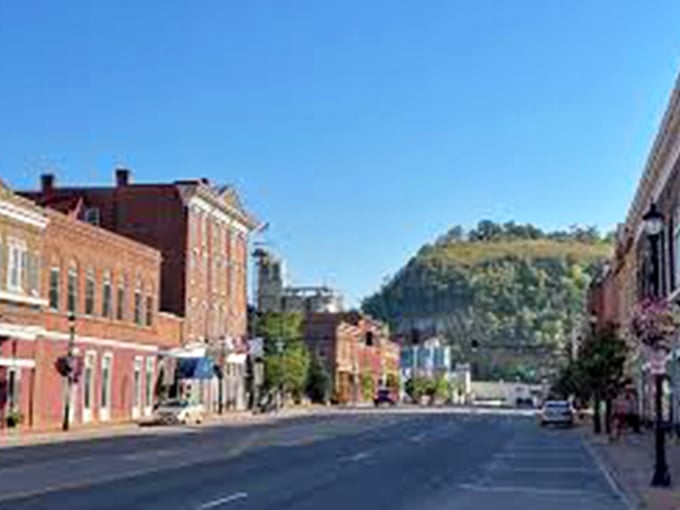 Main Street stretches toward Barn Bluff like a red-brick runway, where historic architecture meets natural splendor in perfect Minnesota harmony.