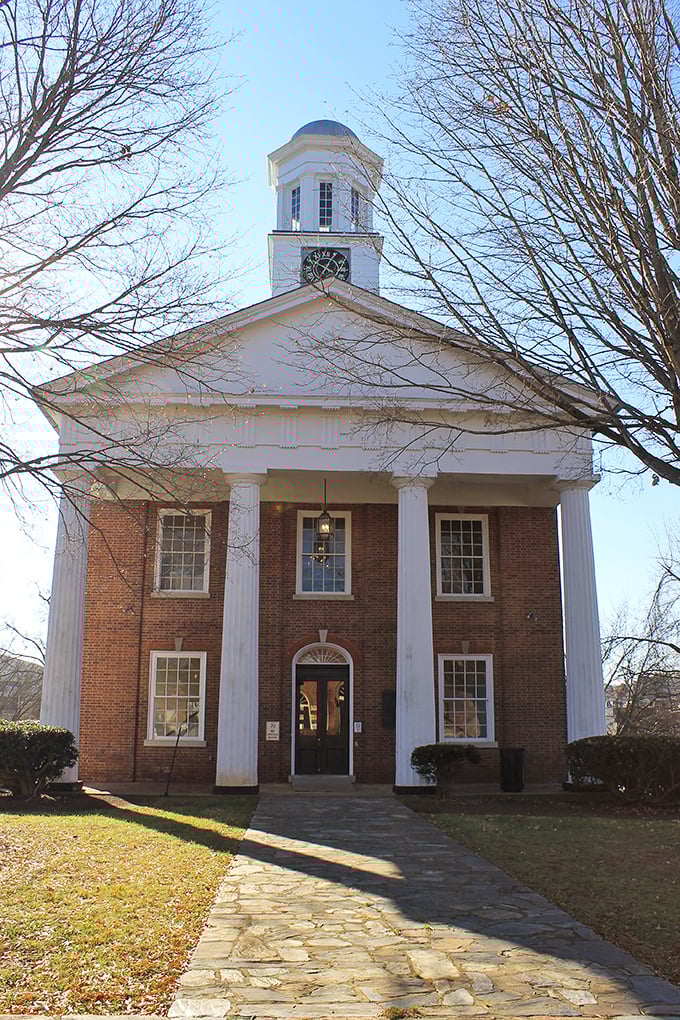 The Old Orange County Courthouse stands like a dignified southern gentleman, its pristine white columns and brick façade witnessing nearly two centuries of community life.