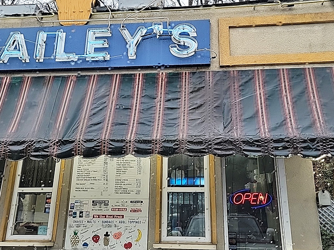 That neon "OPEN" sign might as well say "Happiness Sold Here" - the ordering window at Bailey's is a portal to simpler times.