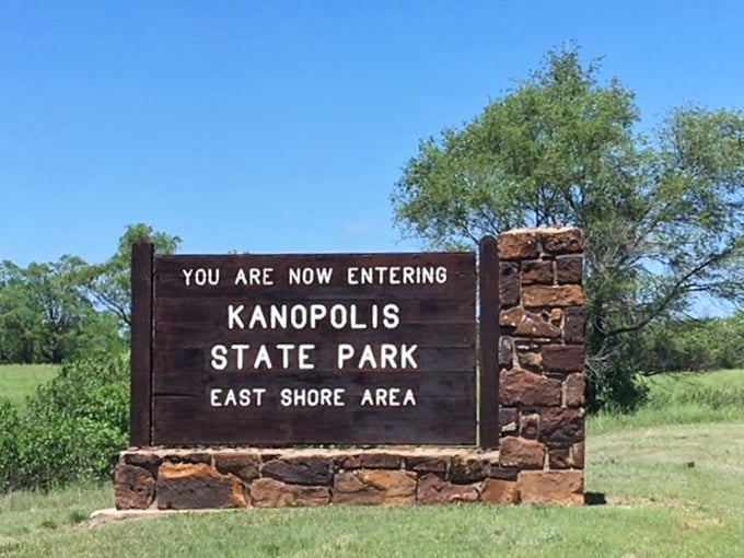 The gateway to adventure: This unassuming entrance sign marks the boundary between ordinary Kansas and an extraordinary natural playground.