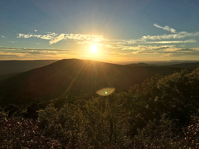 Nature's own light show outperforms Vegas every single time. The Ouachita Mountains frame this golden sunset like a masterpiece.