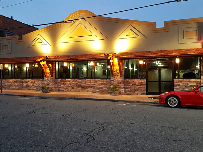By night, this stone-clad restaurant glows with promise, beckoning hungry travelers with the universal language of "come eat here."