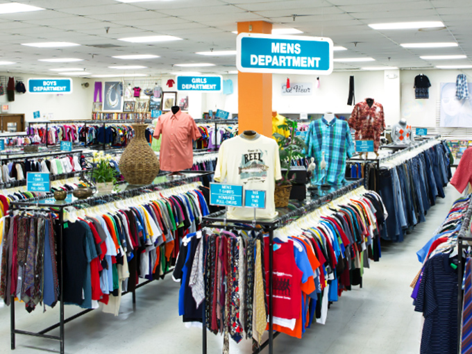 The men's department stretches like a fabric ocean, where Hawaiian shirts loud enough to be heard in Key West mingle with business attire ready for its second career.