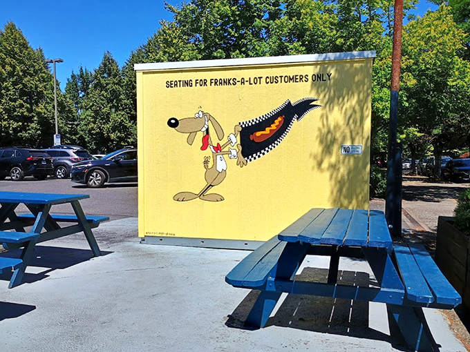 Outdoor picnic tables where strangers become friends over shared condiment packets. The cartoon dog mascot seems to say, "Trust me on this one."