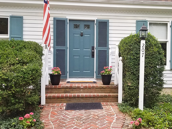 That blue door isn't just an entrance&mdash;it's a time portal to a gentler era, complete with herringbone brick pathway and perfectly symmetrical shrubbery.