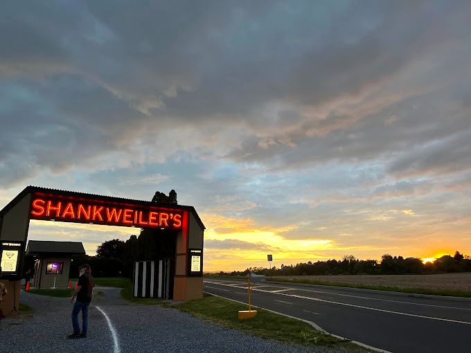 Stars twinkle above as the "Intermission" sign glows against the night sky&mdash;a moment between stories that feels like stepping back in time. 