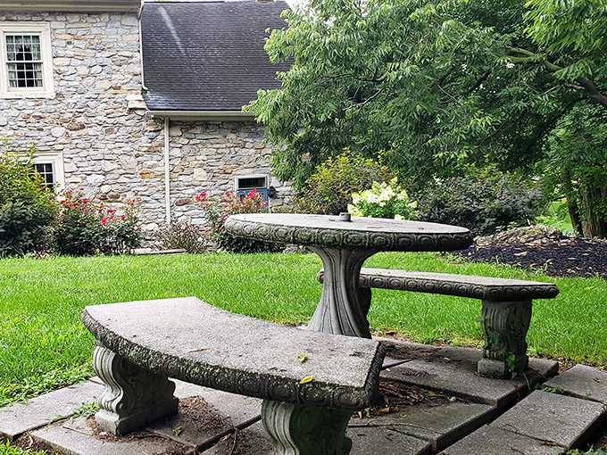 This isn't just any stone picnic table—it's where morning coffee tastes better and conversations linger longer under the watchful gaze of centuries-old stone walls