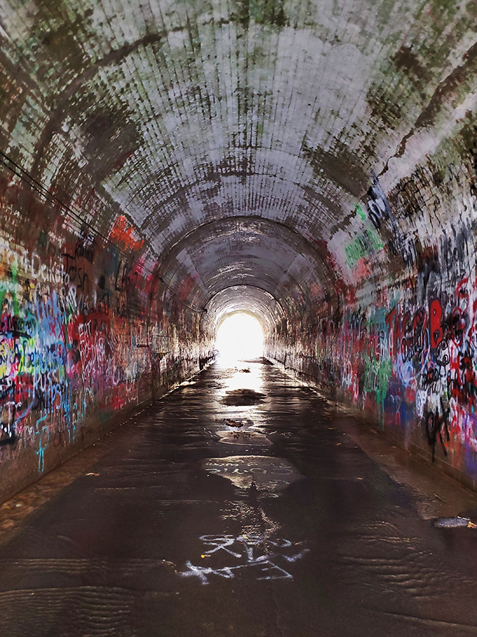 Light at the end of the tunnel isn't always reassuring. The graffiti-lined passage creates a kaleidoscope effect that's equal parts art gallery and horror movie set.