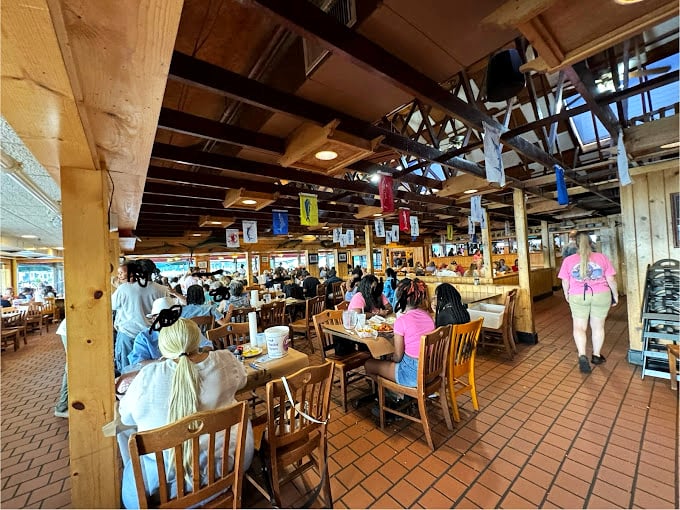 The bustling interior feels like Maryland's living room, where wooden beams and nautical flags create the perfect backdrop for crab-induced happiness.
