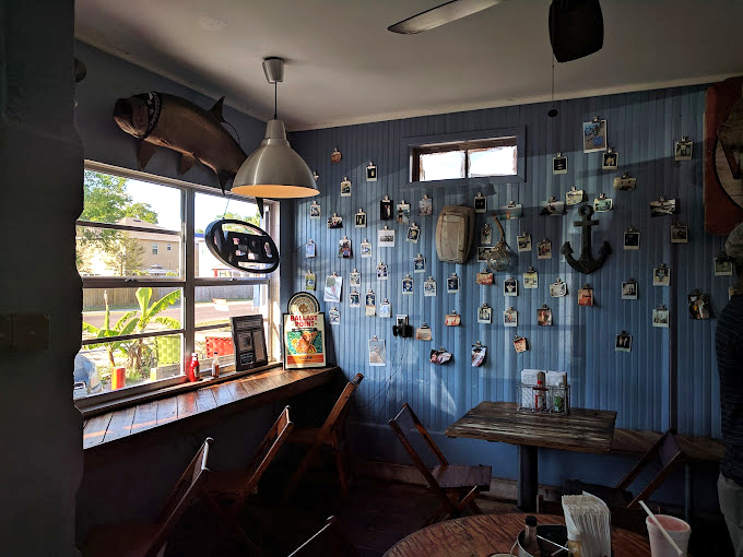 Blue-paneled walls adorned with fishing photos create the perfect maritime atmosphere&mdash;like dining inside a beloved old fishing boat that happens to serve incredible food.