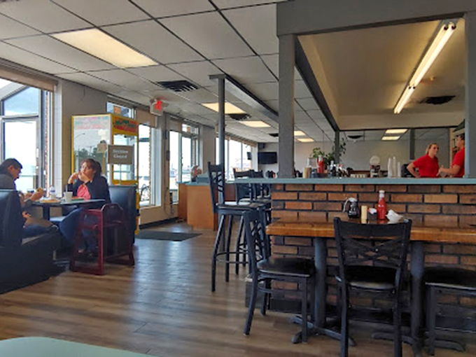 Inside, the warm wood accents and cozy booths create that perfect diner atmosphere where coffee flows freely and conversation comes easy.