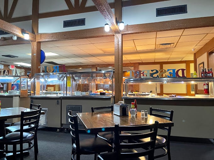 Inside, the buffet stations stretch invitingly across the dining room, where wooden beams and simple tables set the stage for serious eating.