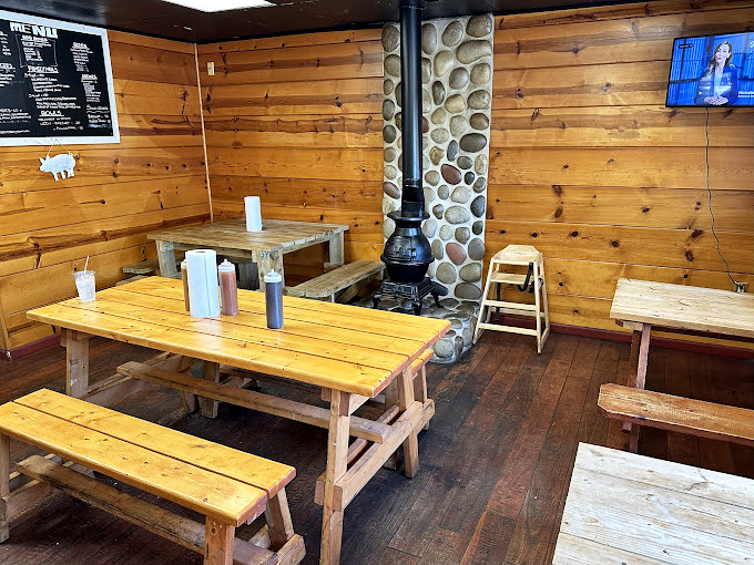 Inside, picnic tables and that stone chimney create the perfect setting for what's about to happen: a serious meat meditation session.