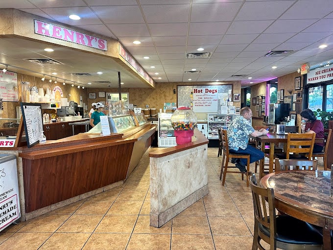 Inside Henry's, the warm wood counters and classic ice cream parlor vibe create that rare atmosphere where time slows down and calories don't count. 