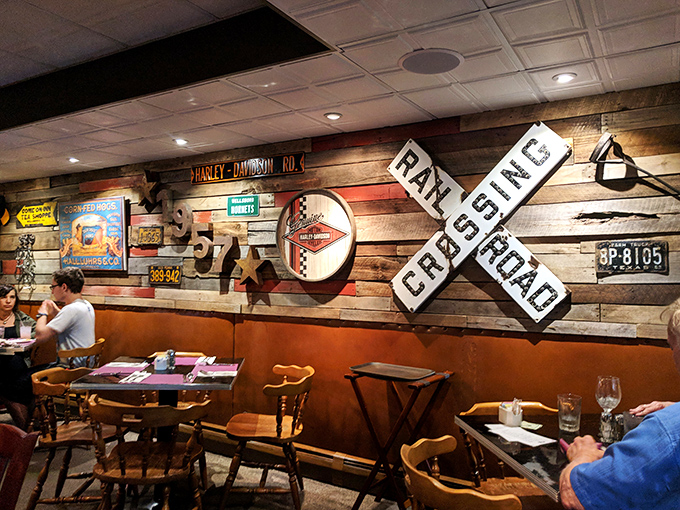 Rustic charm meets roadside Americana on these walls. The railroad crossing sign isn't just decoration—it's warning you to slow down and savor every bite.