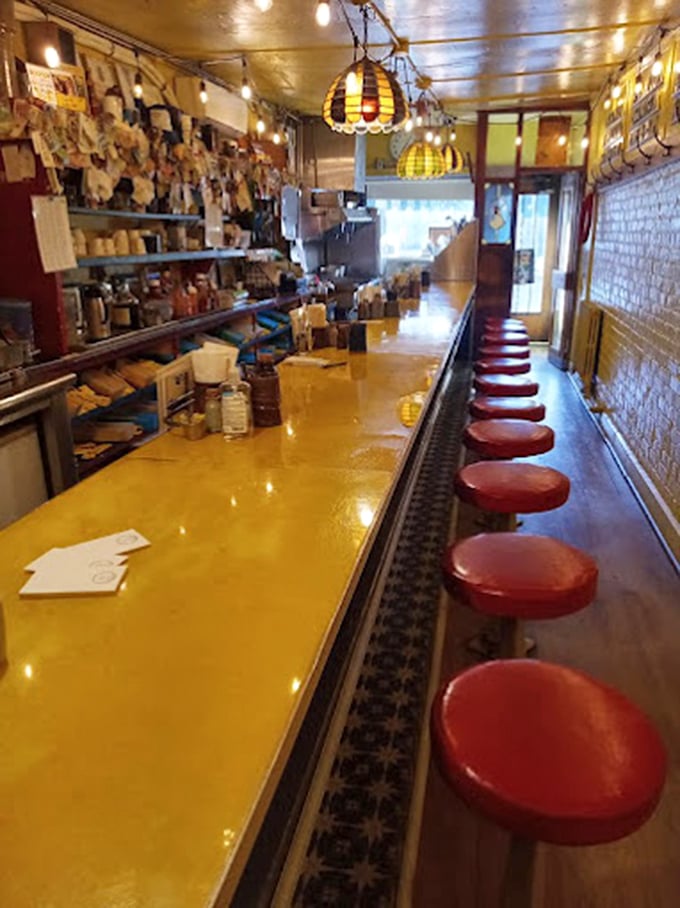 Fourteen red stools, one yellow counter, and endless breakfast possibilities. This narrow galley kitchen serves up joy by the plateful in just 10 feet of width.