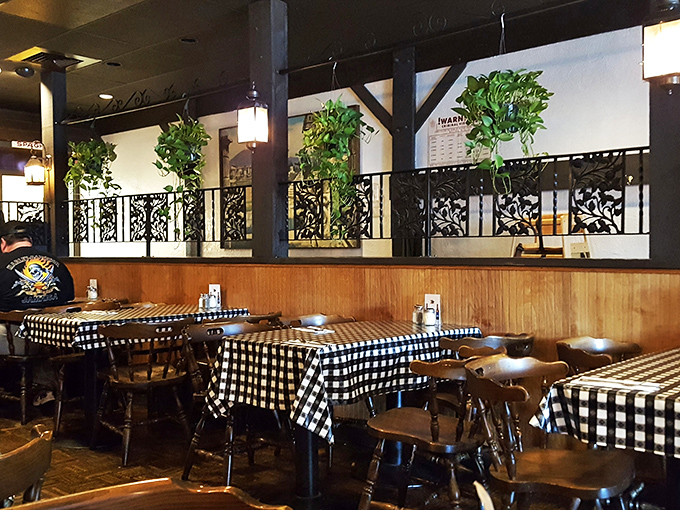 Black and white checked tablecloths and wooden dividers create that perfect "nobody's rushing you out" atmosphere where memories are made between bites.