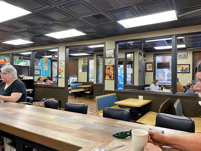 Inside, the classic diner aesthetic meets Southern charm with tin ceiling tiles and cozy booths where breakfast dreams come true.