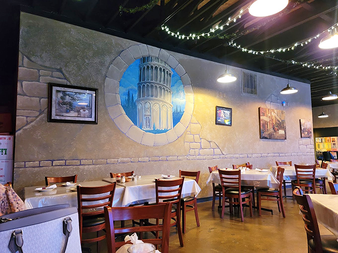 Step inside and you're transported to a slice of Italy with faux-stone walls, twinkling string lights, and that Leaning Tower mural that makes every meal feel like a mini-vacation.