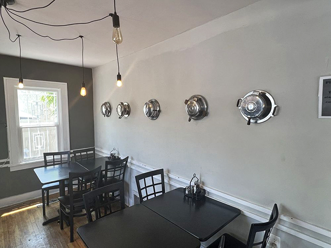 Inside, vintage hubcaps adorn minimalist walls while Edison bulbs cast a warm glow—proof that waffle artistry deserves proper gallery lighting.