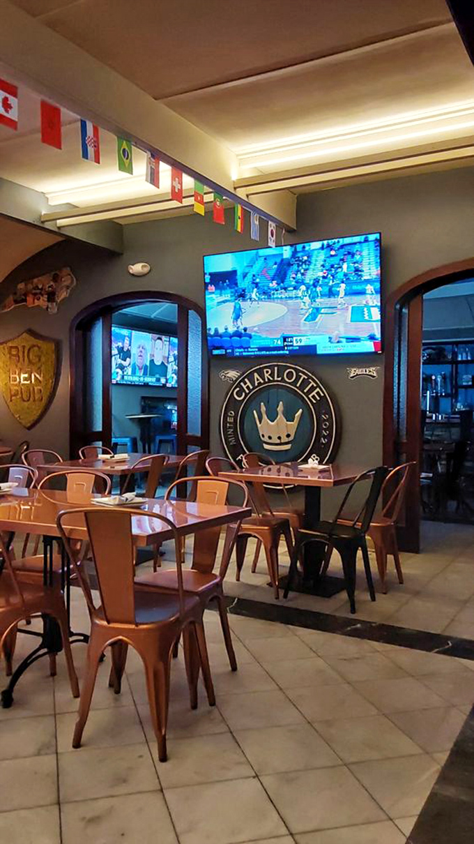Inside, international flags hang above tables where sports fans gather. The Charlotte crown emblem reminds you you're still in the Queen City.
