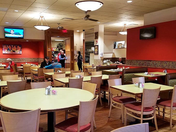 Inside, the warm red walls and comfortable seating create the perfect backdrop for family gatherings and solo dining adventures alike.