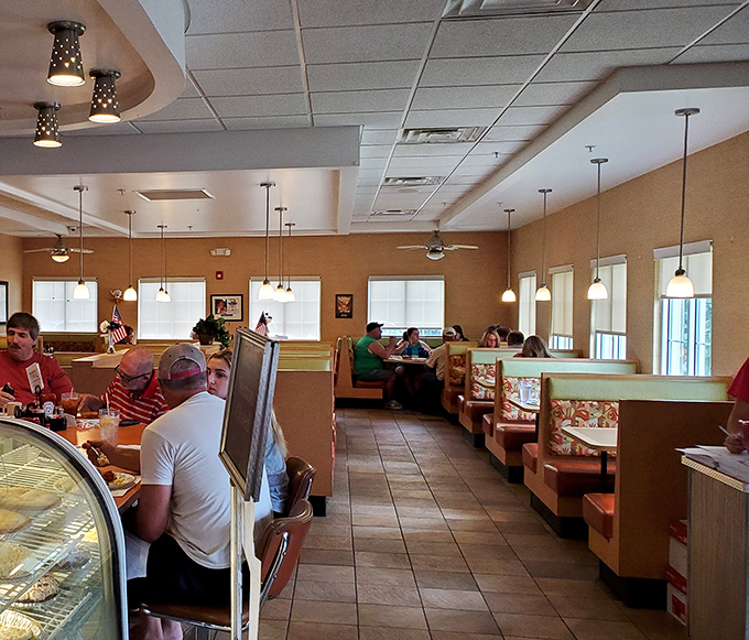 Inside, the warm amber tones and classic booth seating create that perfect diner atmosphere where conversations flow as freely as the coffee.