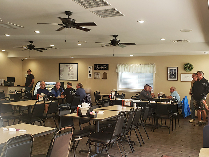 Inside, ceiling fans lazily spin above a gathering of locals who know that true happiness comes served on white plates.