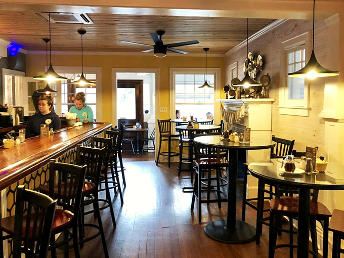 Warm wooden ceilings, honey-yellow walls, and cozy seating create the perfect backdrop for morning conversations that stretch into afternoon.