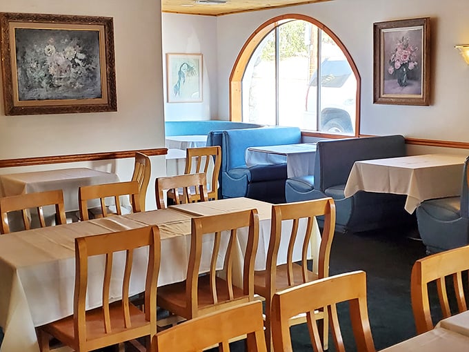Elegant simplicity reigns in this dining room where the arched window frames California sunshine while the tables await Gallic indulgence.