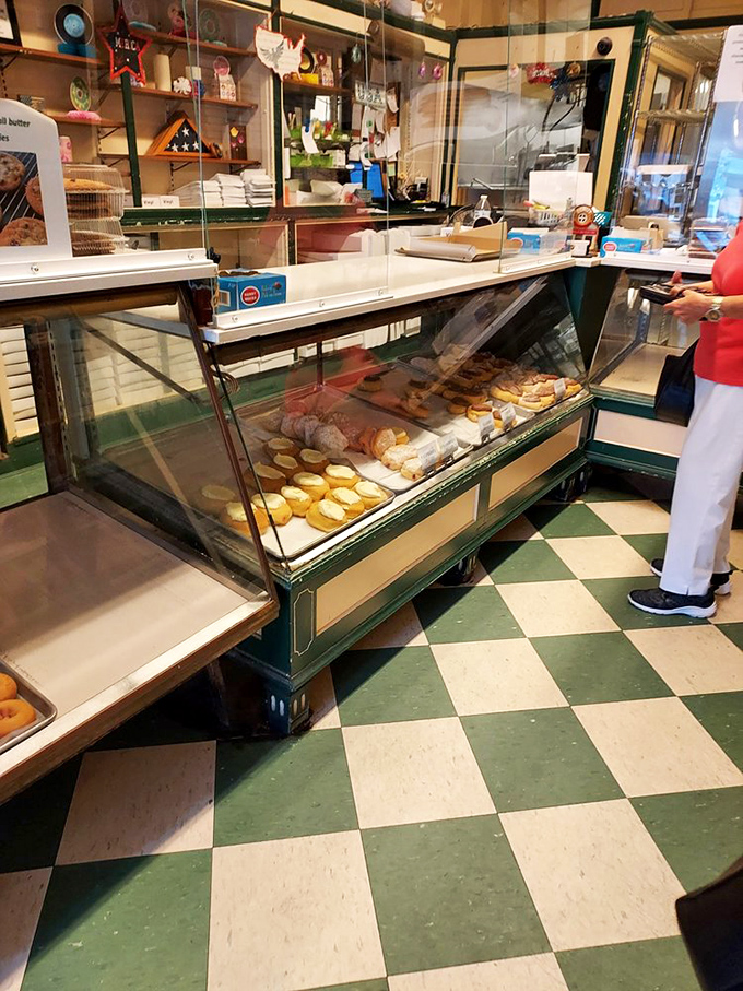 The checkerboard floor has supported generations of eager customers. At Oram's, the display case isn't just furniture&mdash;it's a portal to happiness.