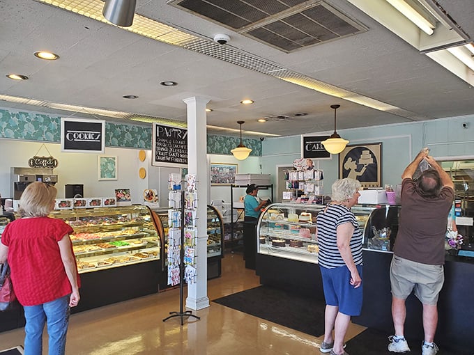 Inside Bing's, the dance of customers eyeing display cases is a daily ritual. The light blue walls and vintage charm create a backdrop for serious dessert decisions.