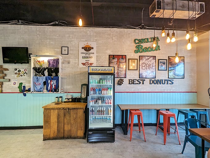 Inside, beach vibes meet donut paradise with turquoise wainscoting and exposed Edison bulbs. The "BEST DONUTS" sign isn't bragging&mdash;it's just stating facts.