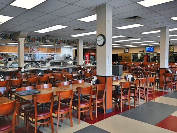 Cafeteria-style dining where the wooden chairs have witnessed more food epiphanies than a cooking show marathon. The checkerboard floor says "classic" while your stomach says "hurry up and order already."
