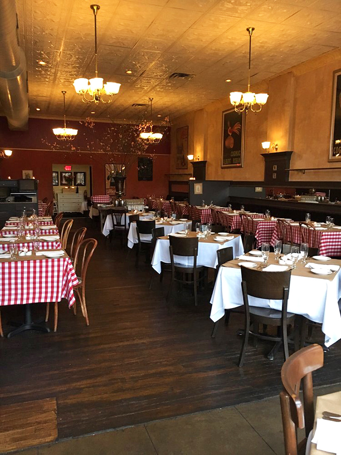 Red-and-white checkered tablecloths, warm lighting, and classic French posters transport you straight to Paris without the jet lag or passport control.