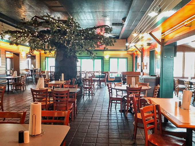 Warm wood tones, comfortable seating, and that whimsical tree centerpiece create the perfect backdrop for serious burger business.