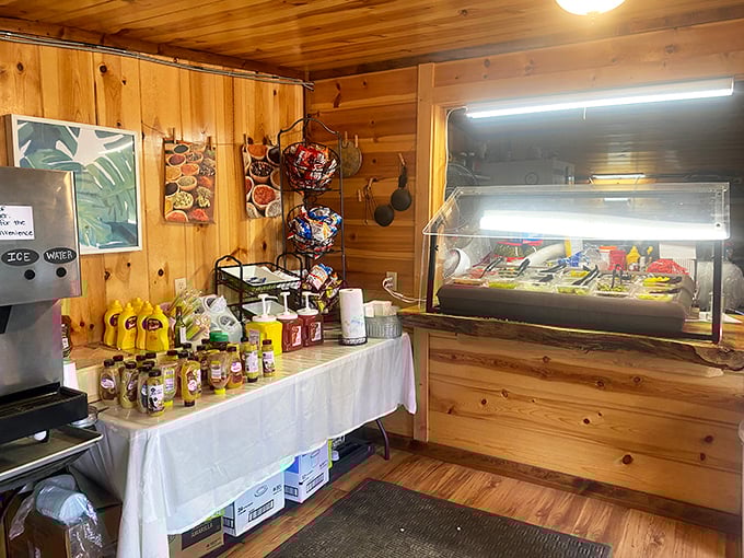 Inside, pine-paneled walls create a cozy cabin vibe where culinary magic happens behind a simple counter. No frills, just flavor.