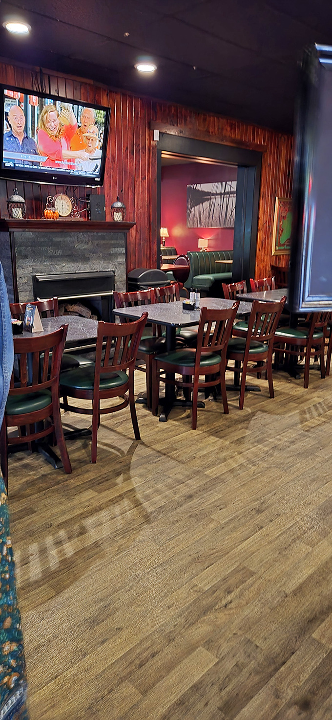 Warm wood paneling, a stone fireplace, and those classic restaurant chairs that somehow always feel like coming home.